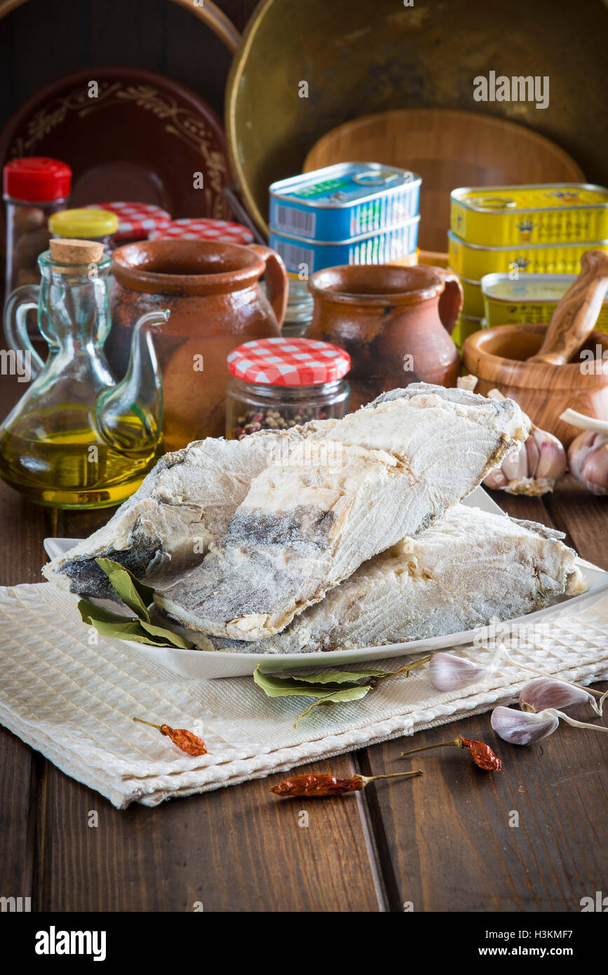 Salted cod cut with ingredients and utensils on the table of the ...