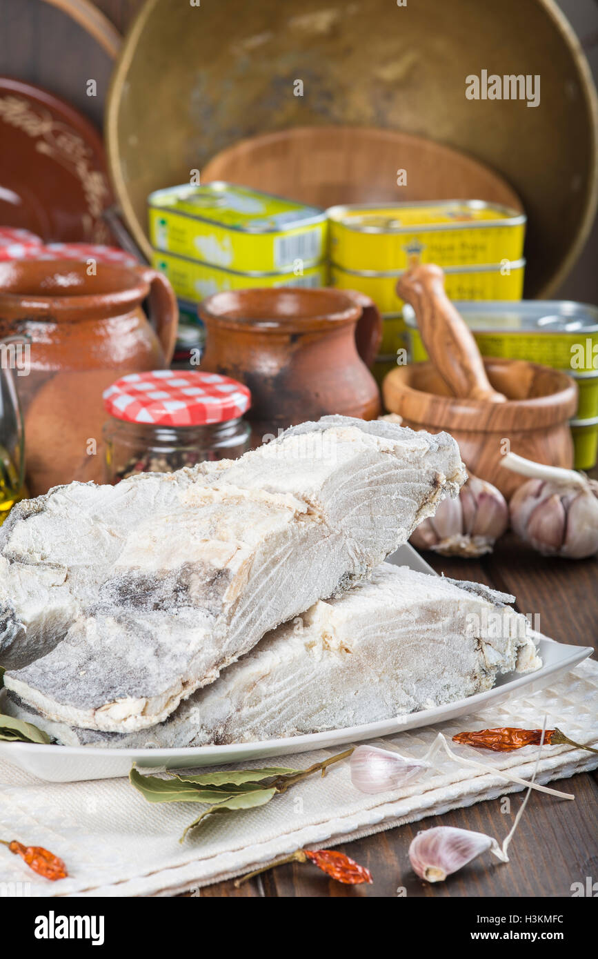Salted cod cut with ingredients and utensils on the table of the ...