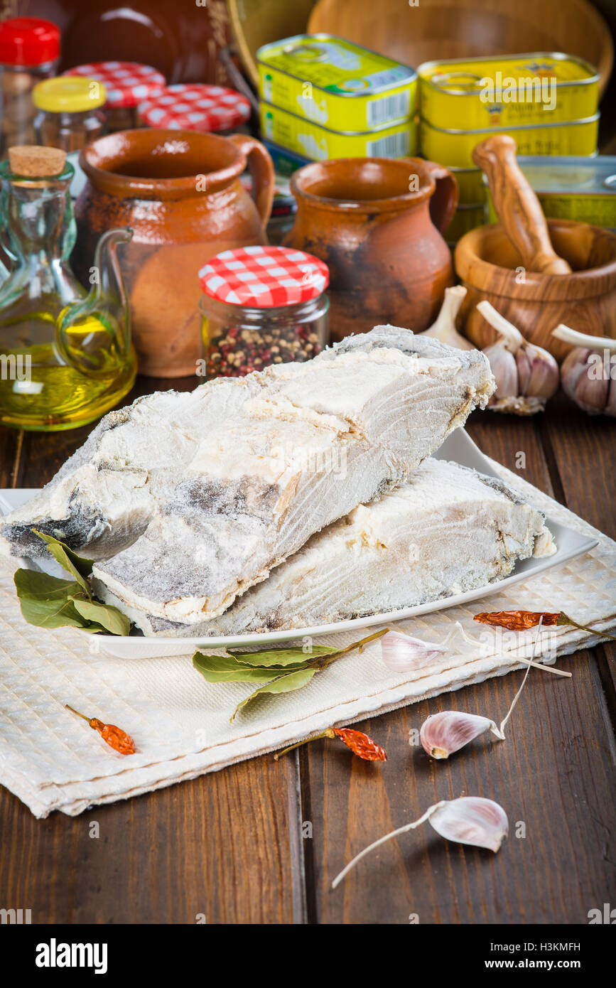 Salted cod cut with ingredients and utensils on the table of the ...