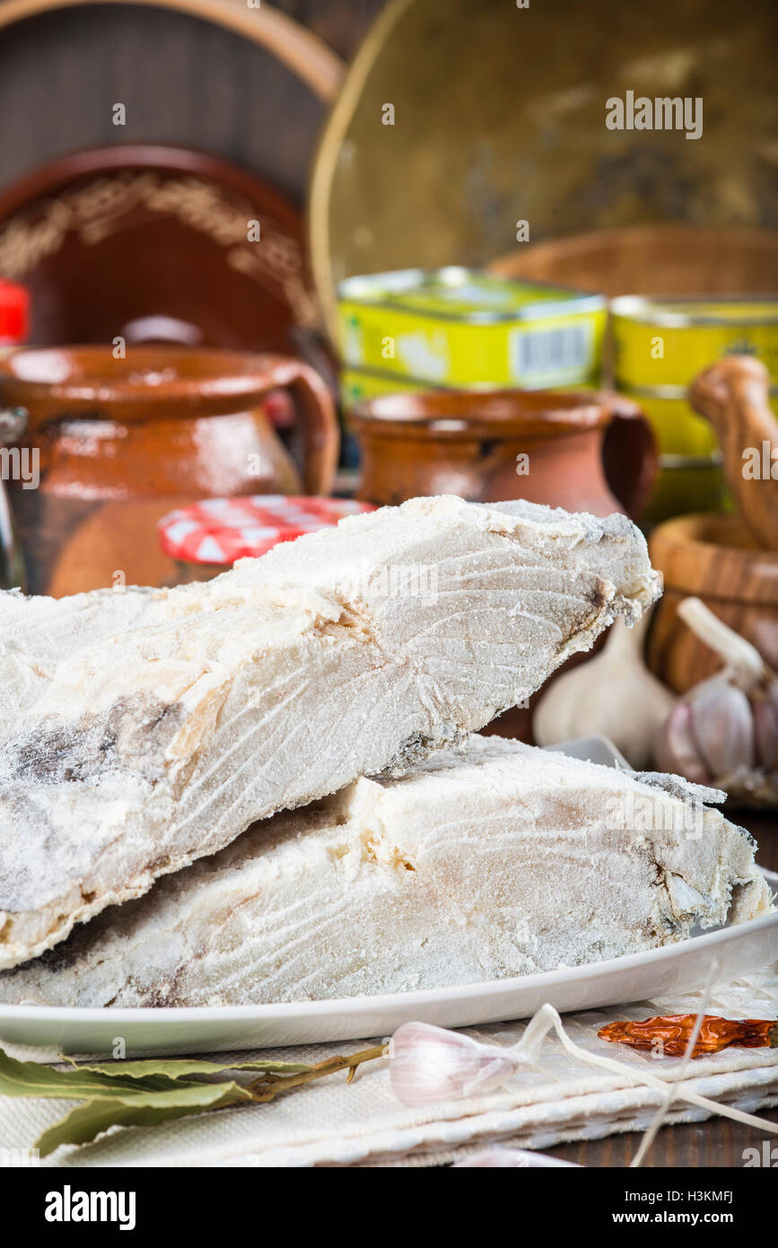 Salted cod cut with ingredients and utensils on the table of the ...