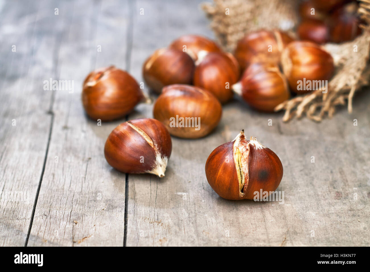 Roasted sweet chestnuts on grey rustic wooden table. Copy space Stock ...