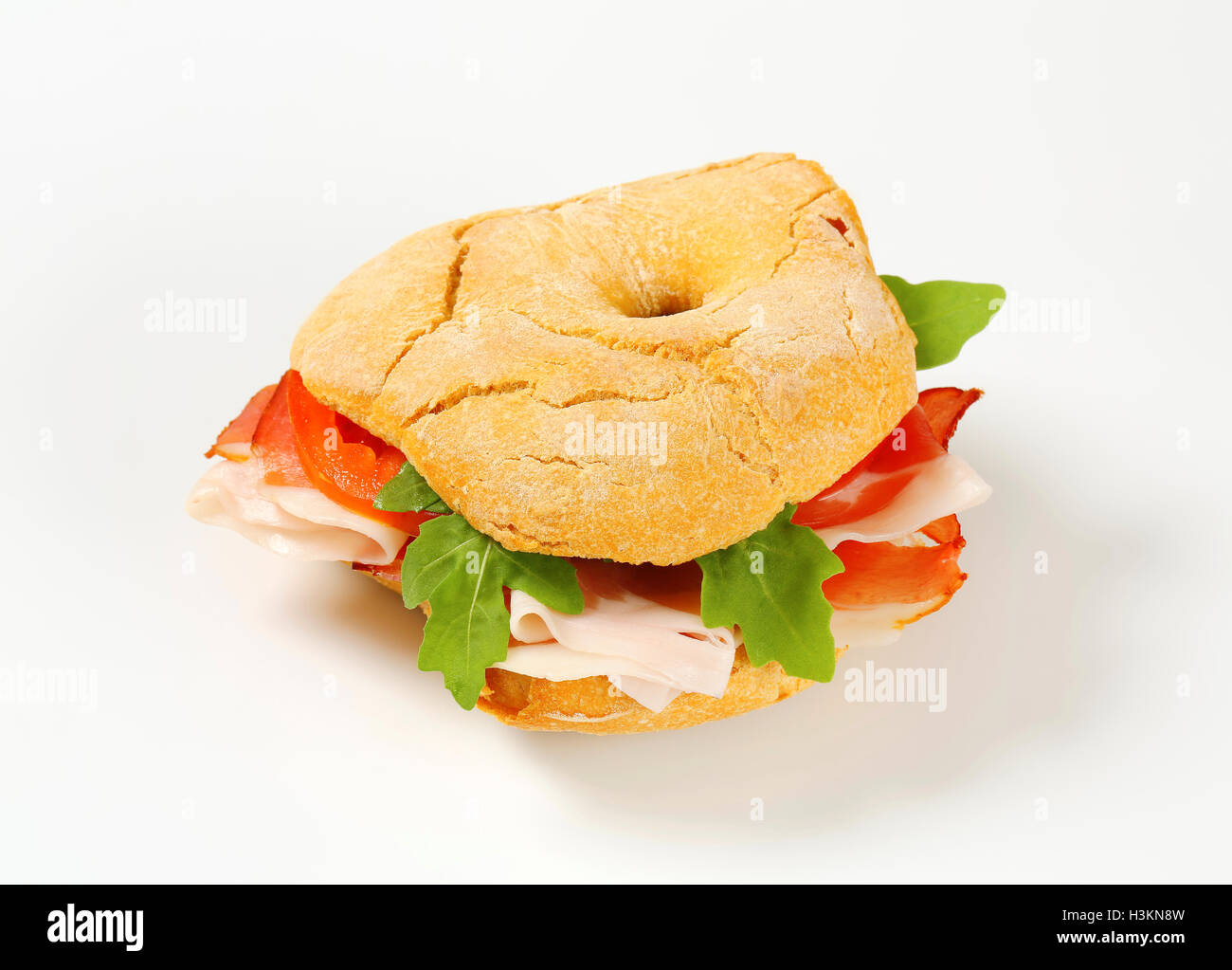 Ring-shaped bread roll with slices of prosciutto Stock Photo - Alamy
