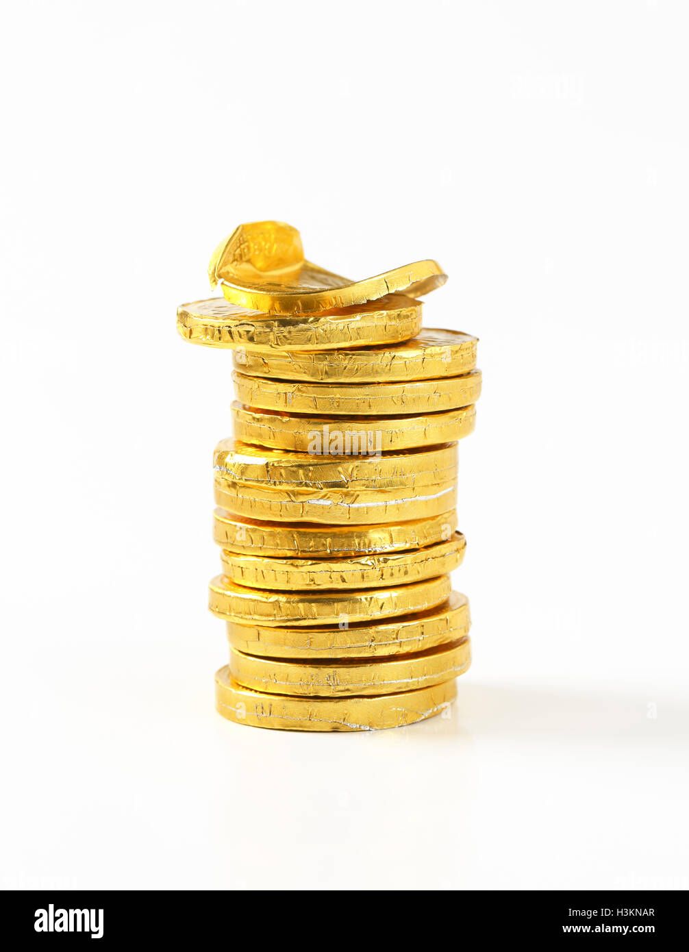 stack of chocolate coins on white background Stock Photo - Alamy