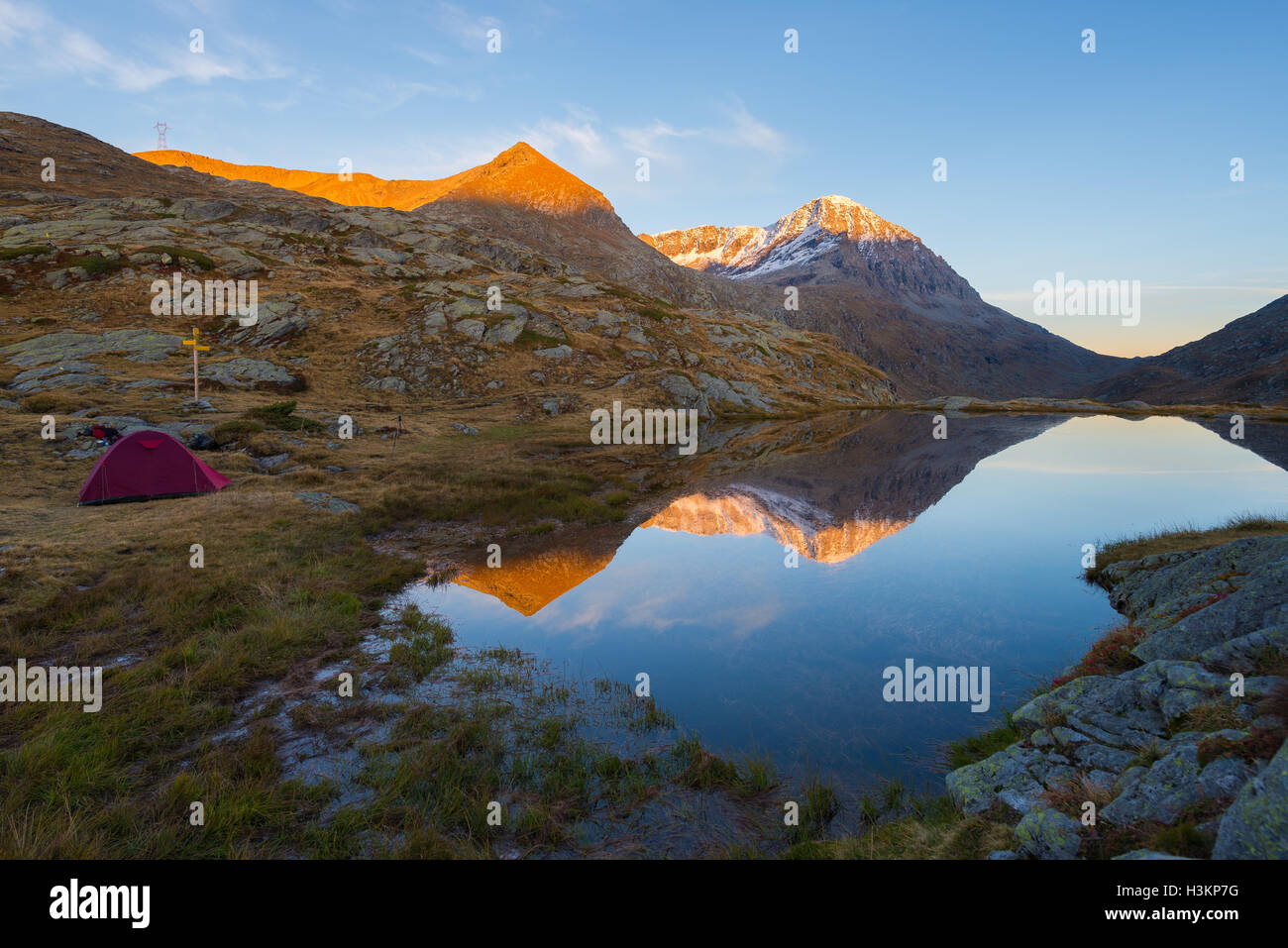 Camping with tent near high altitude lake on the Alps. Reflection of ...