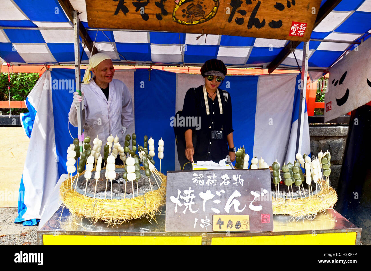Traveler thai woman test cooking and take photo with vendor dango ...