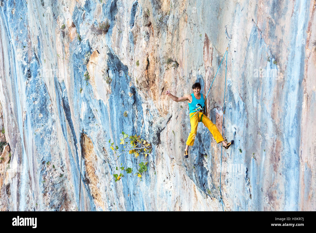 Smiling male Rock Climber descending on Rope with Okey hand sign Stock ...
