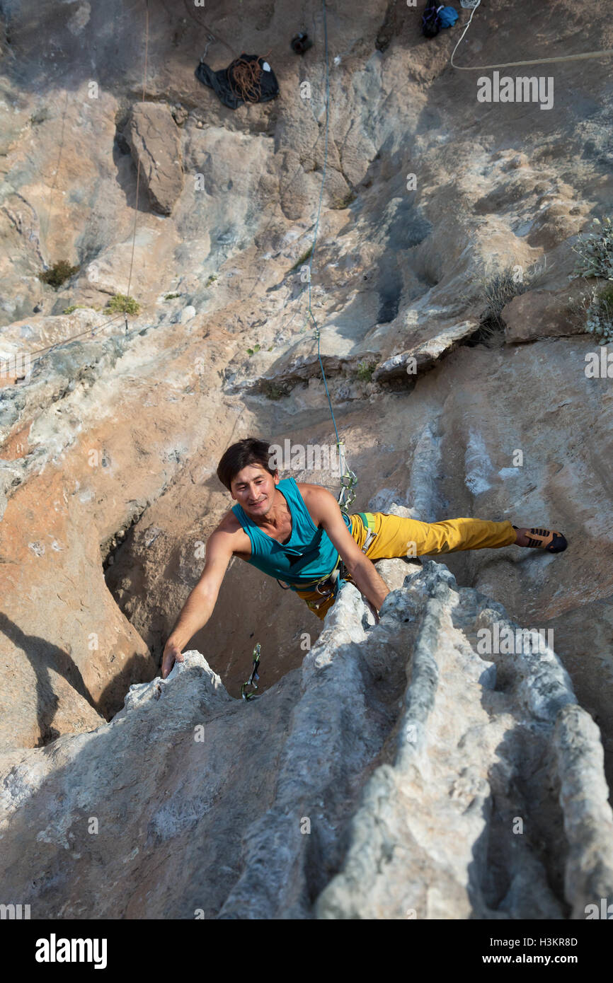 Smiling Male Extreme Climber hanging on unusual shaped Rock Stock Photo ...