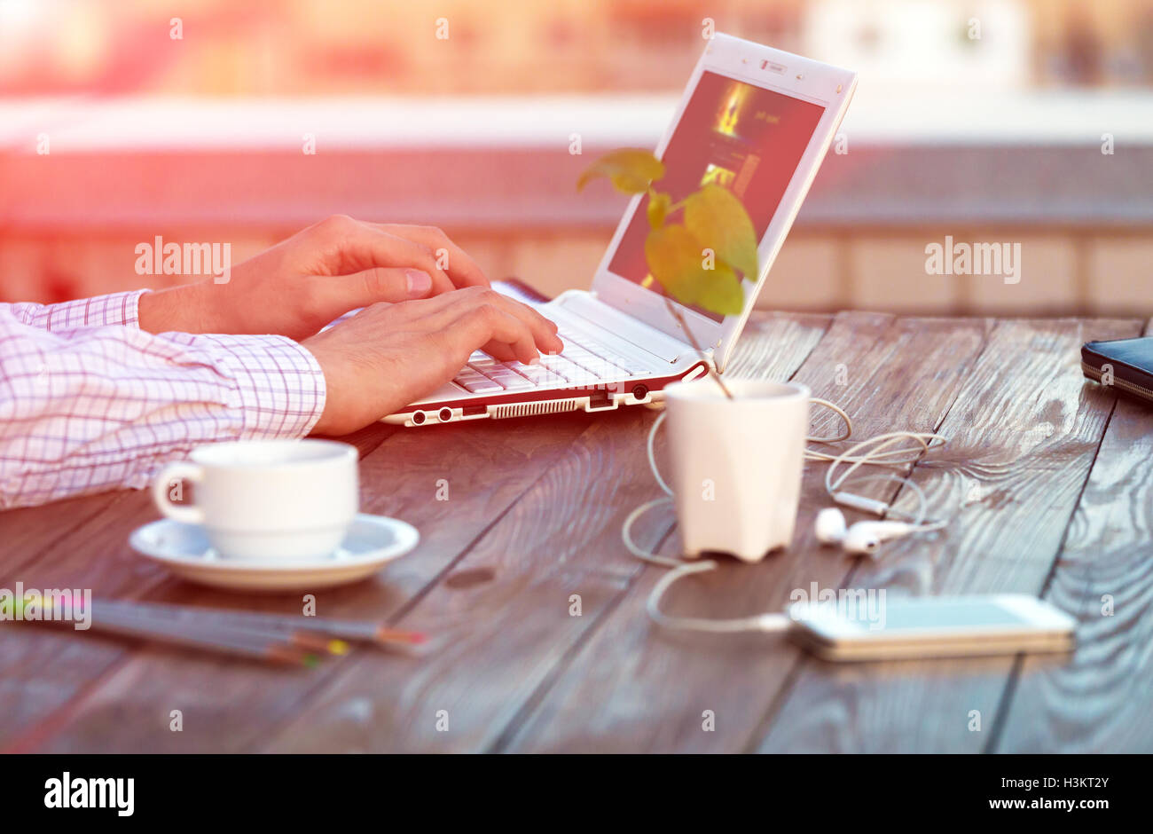 Freelance work at wood Table located on outdoor terrace Stock Photo - Alamy