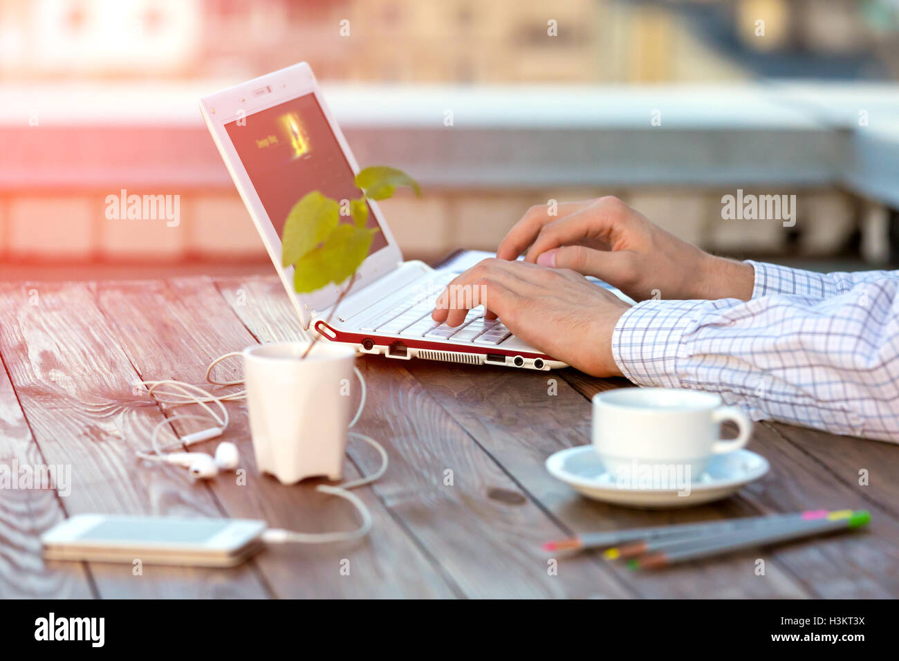 Freelance work at wood Table located on outdoor terrace Stock Photo - Alamy