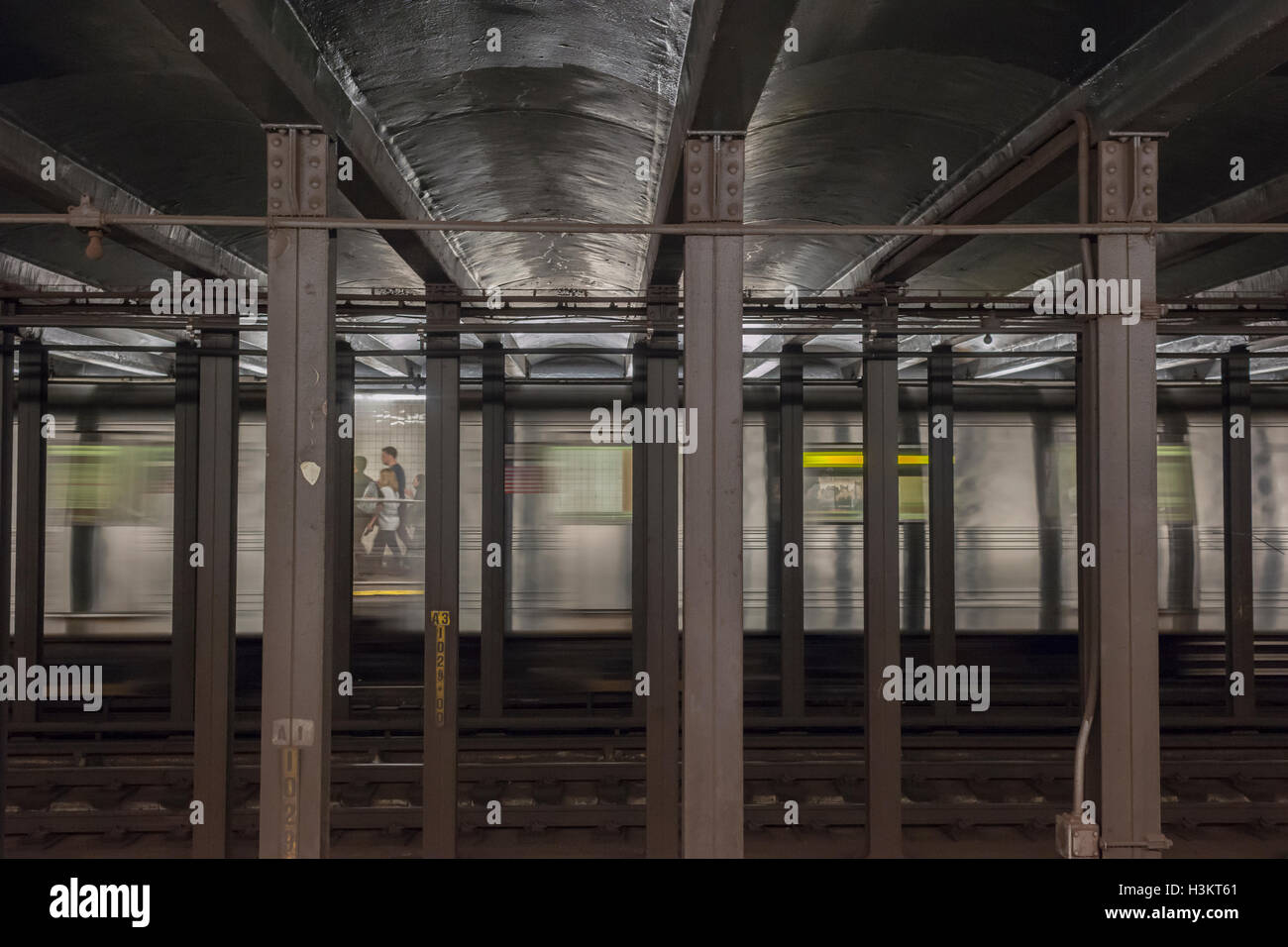 A subway train in New York departs the 23rd Street IND station on ...
