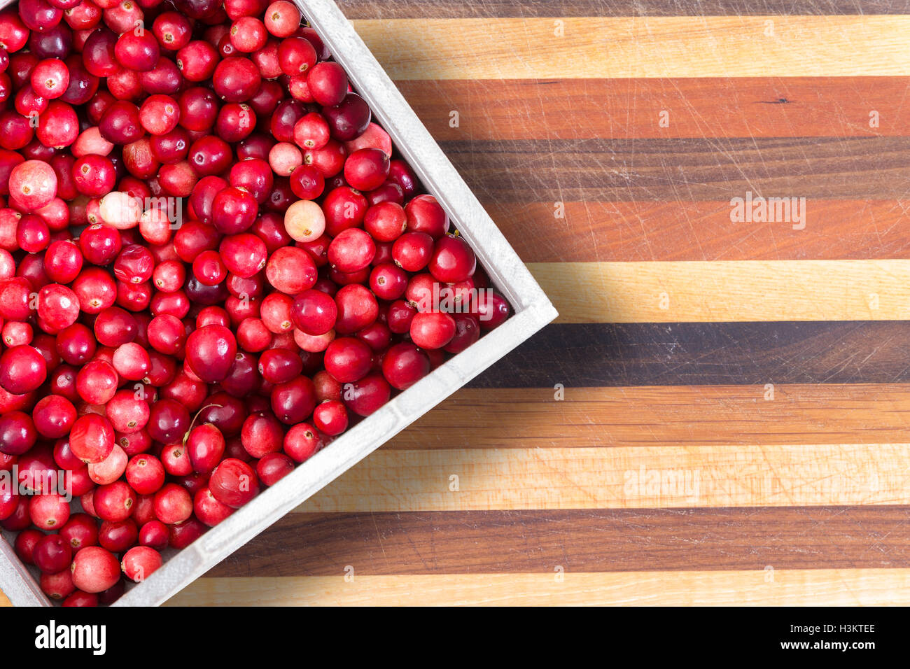 Full punnet of fresh ripe red cranberries ready for use in cooking on ...