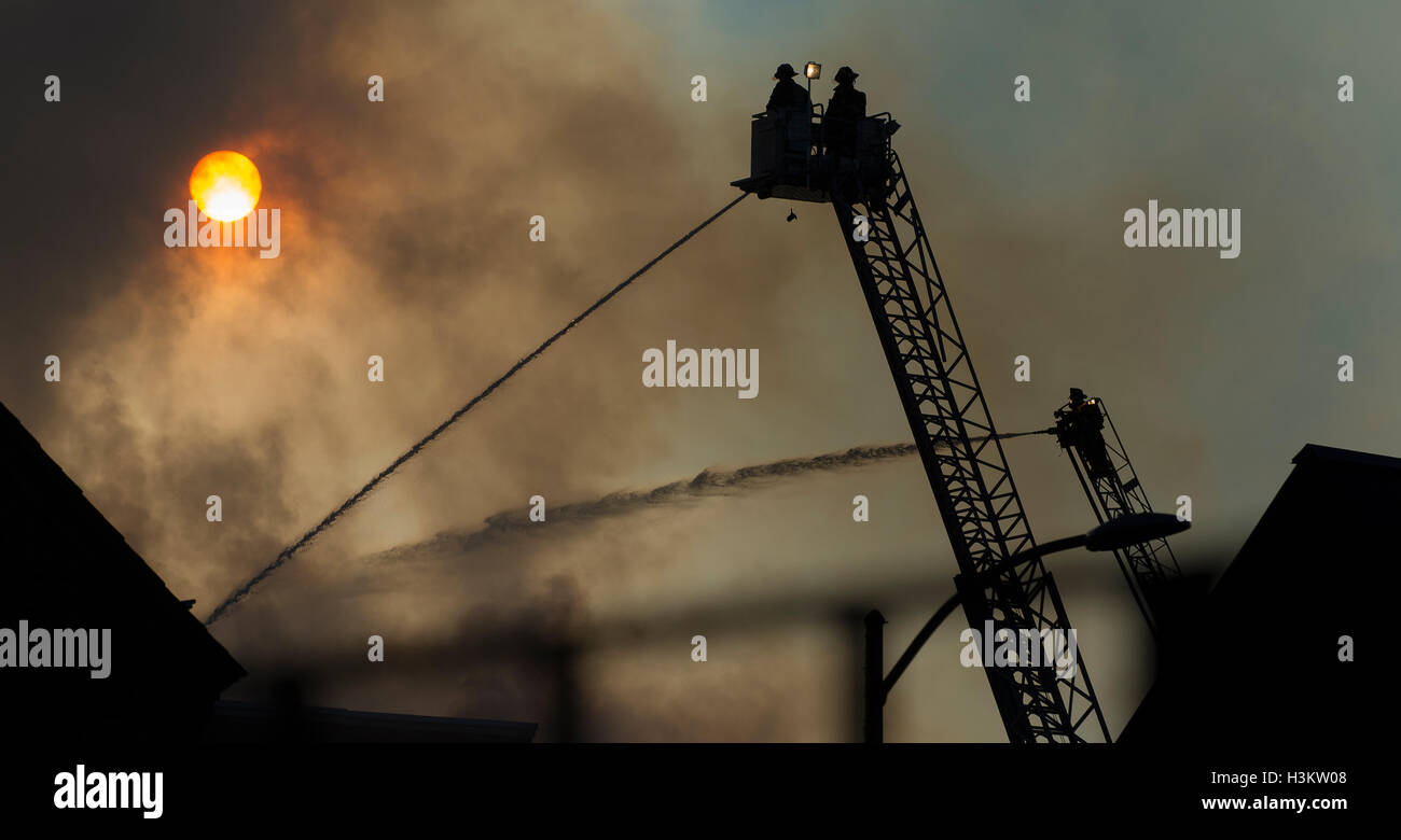 A Tower Ladder and aerial ladder pipe play water into a vacant school ...