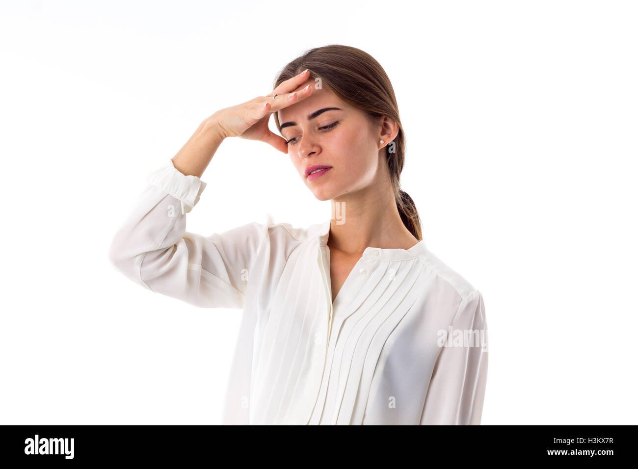 Woman holding hand at her forehead Stock Photo - Alamy