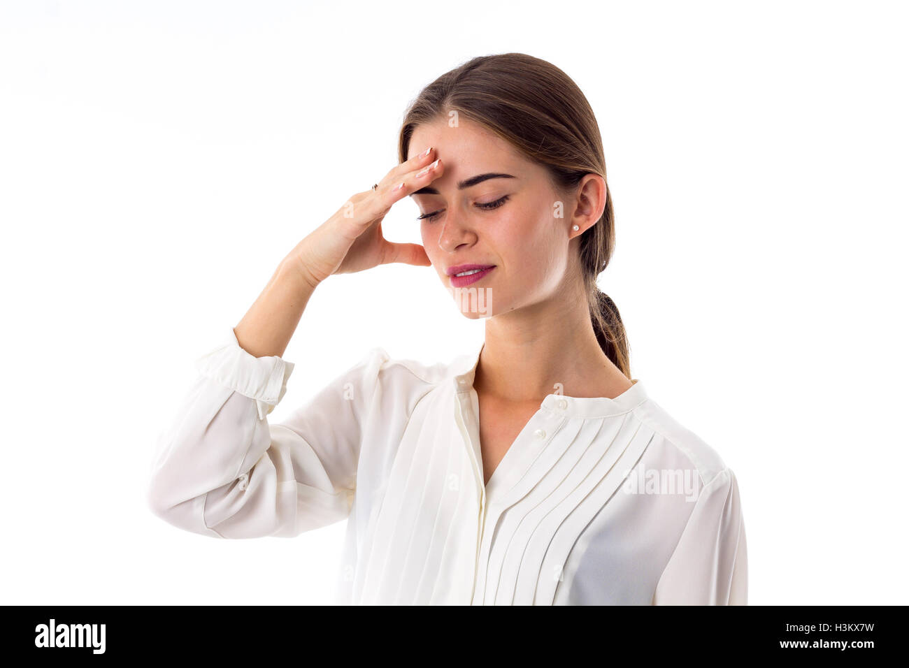 Woman holding hand at her forehead Stock Photo - Alamy