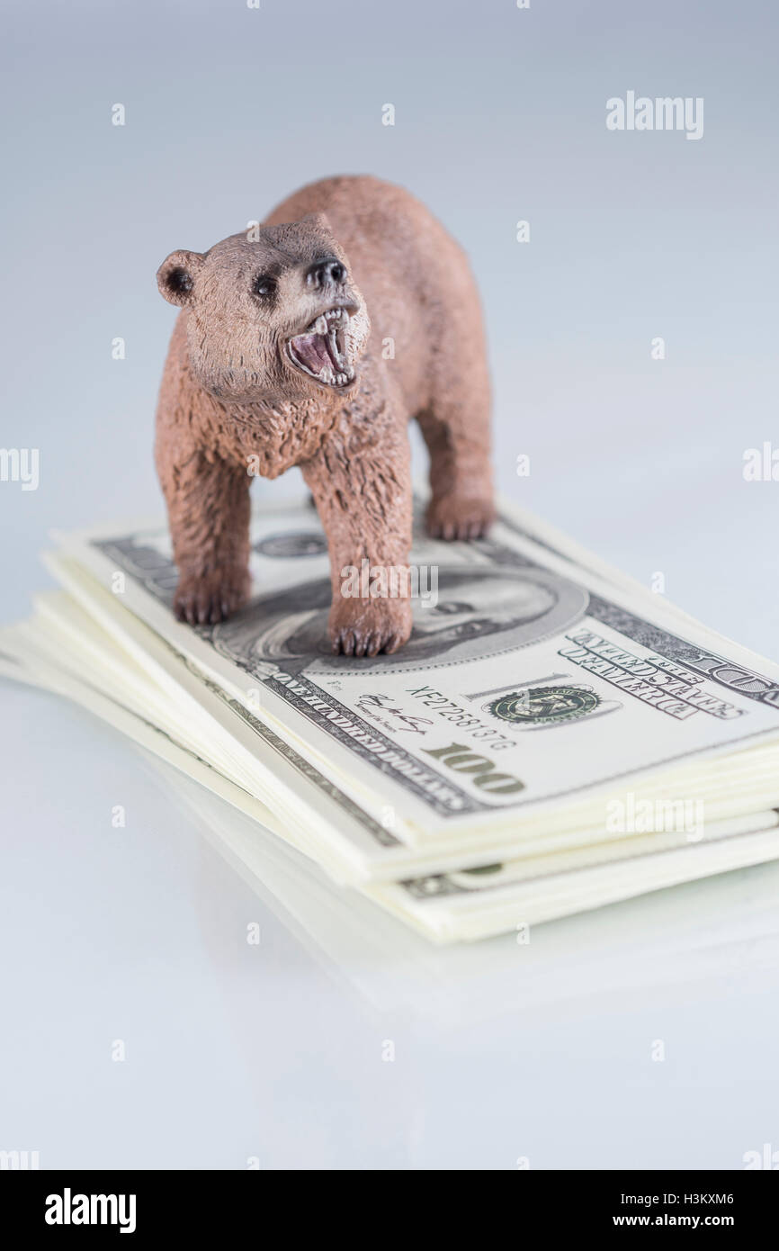 Bear with pile of US 100$ Franklin bills / banknotes, as metaphor for ...
