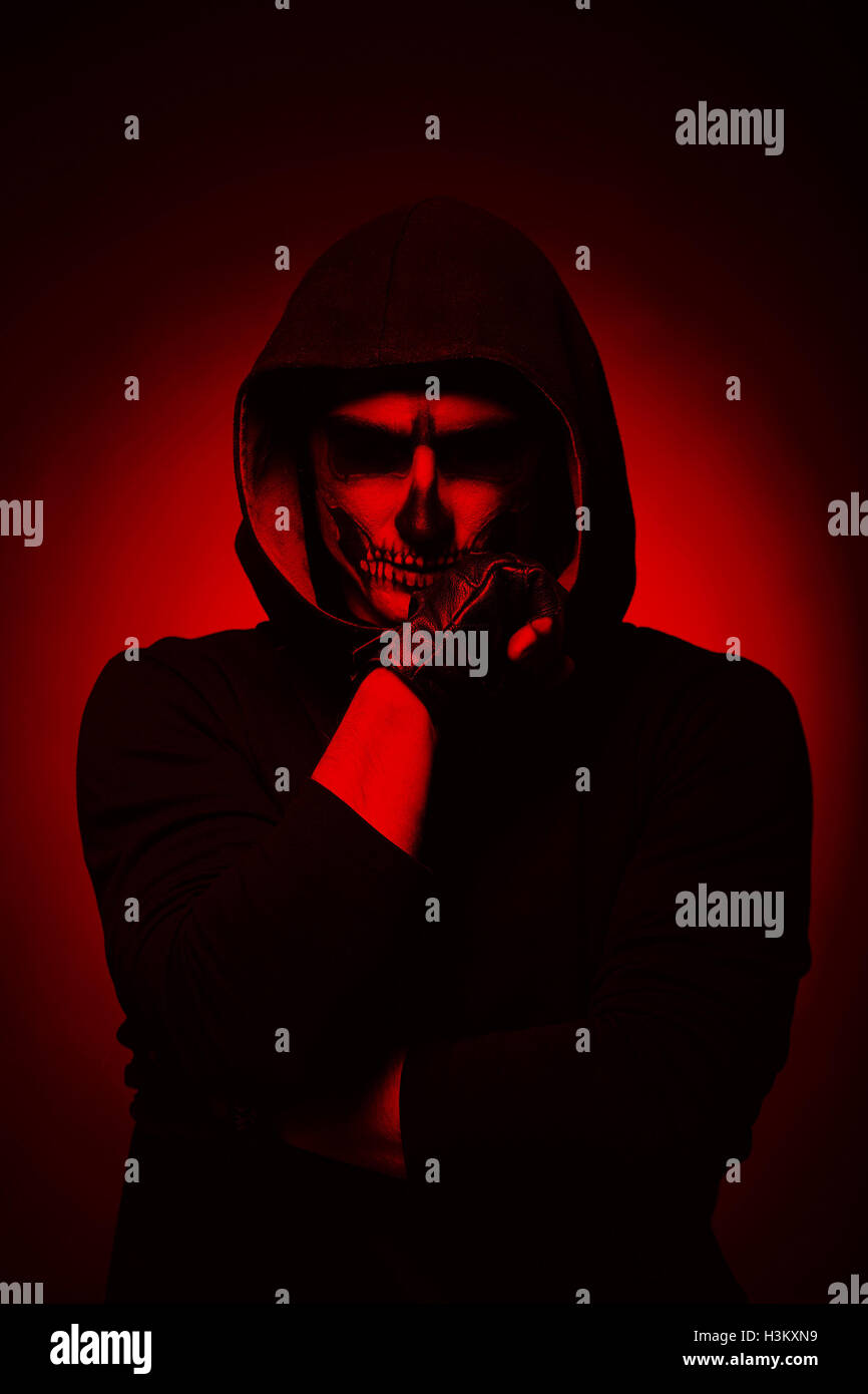 Evil man on black background Stock Photo - Alamy