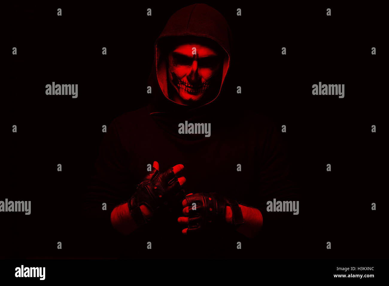 Evil man on black background Stock Photo - Alamy