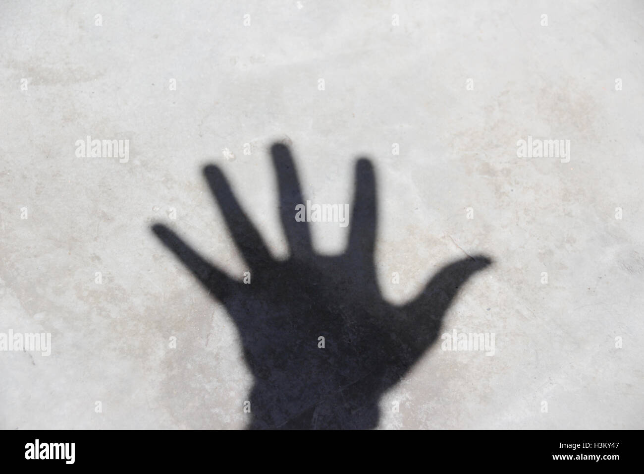 Photograph of an open hand shadow or silhouette on floor Stock Photo ...