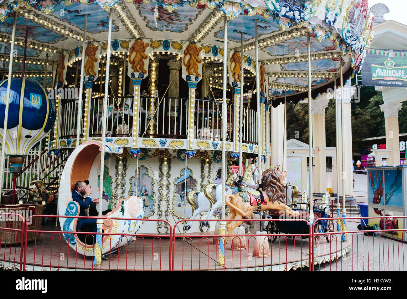 adult man and woman on a carousel Stock Photo - Alamy