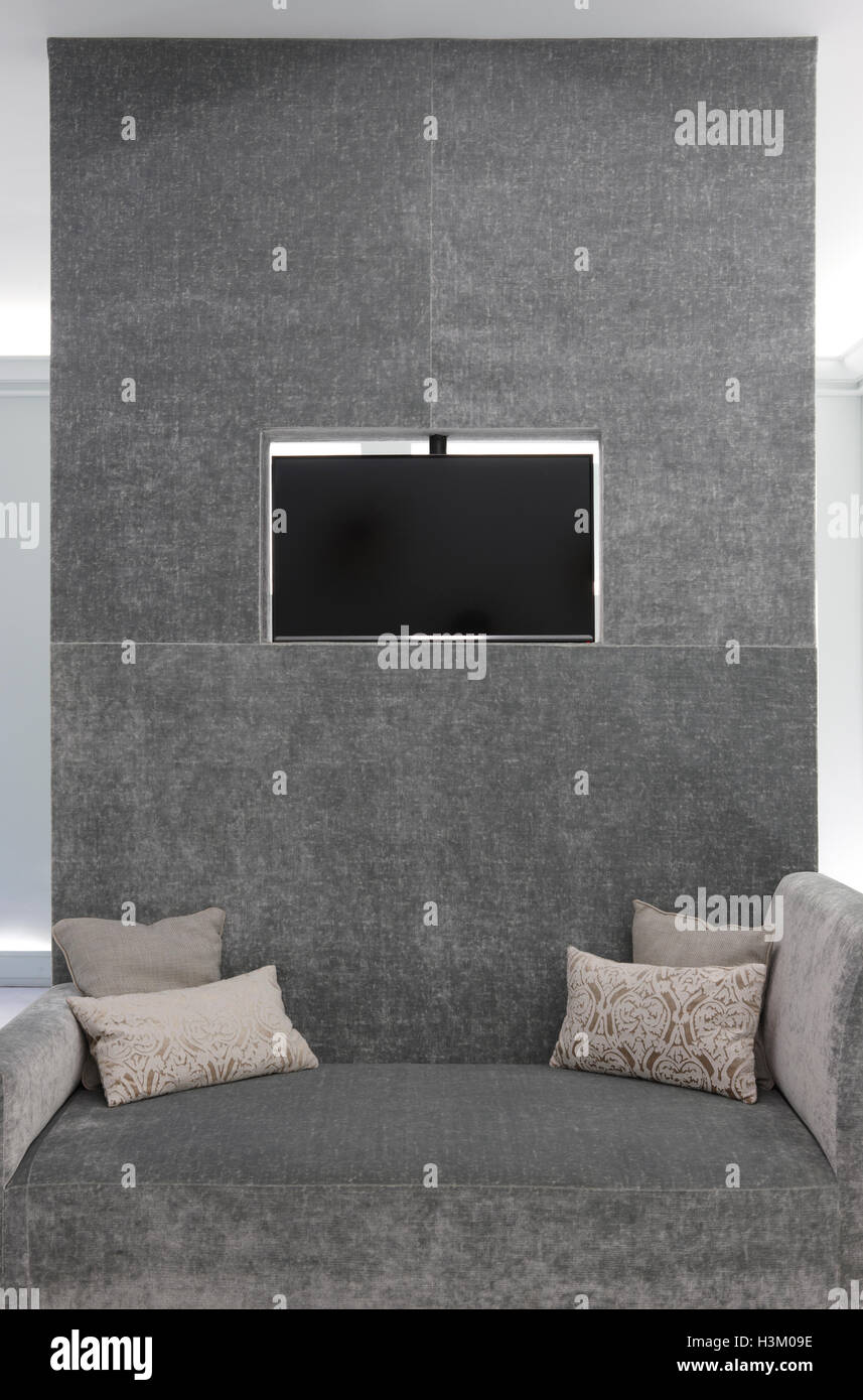 Living room with couch and tv set in grey tone. Vertical Stock Photo ...