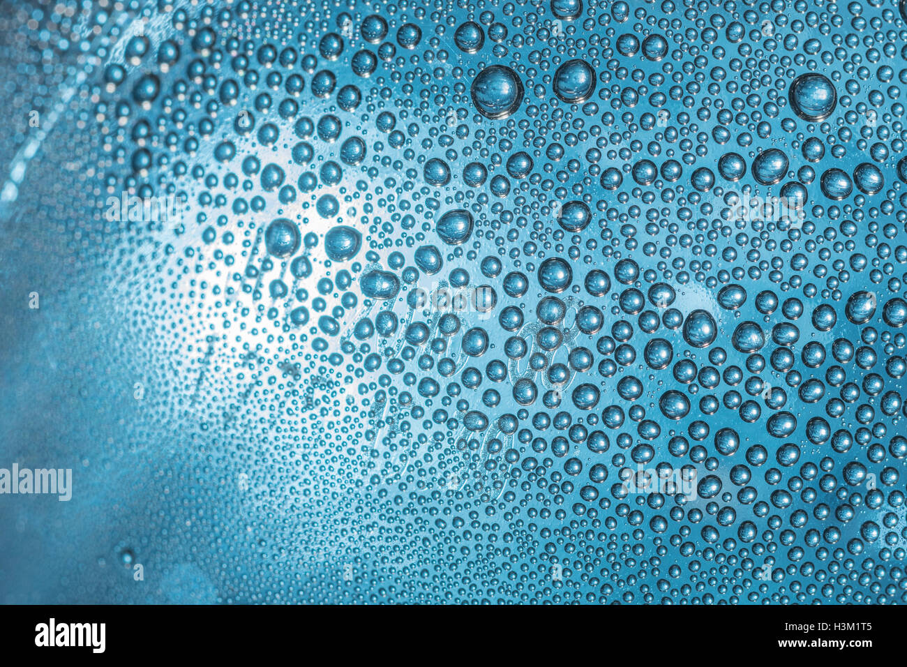Abstract image of beads of water condensation on the inside of a PTFE bottle. Some 'batch' ID ...