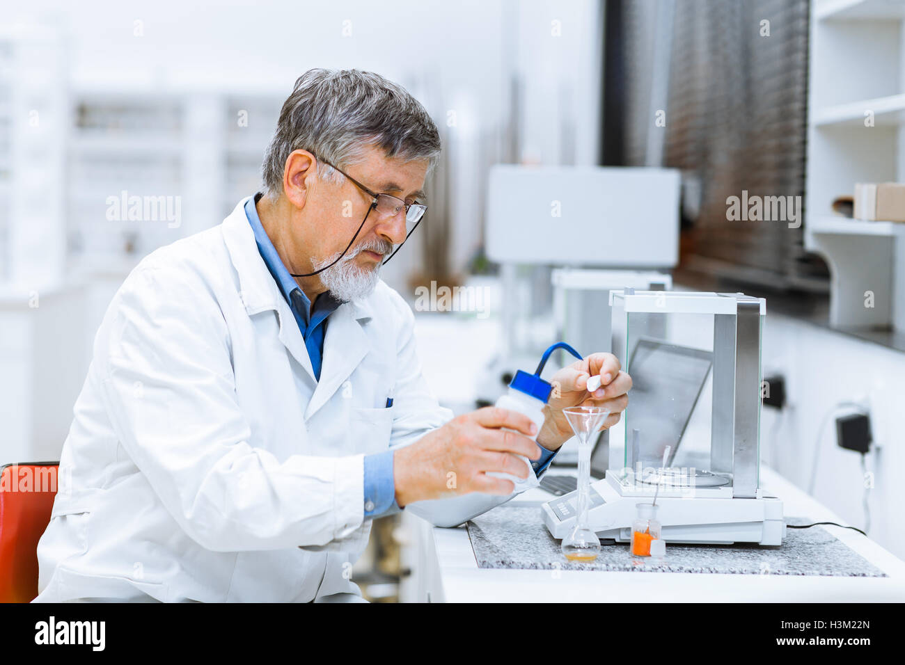 Senior male researcher carrying out scientific research in a lab Stock ...