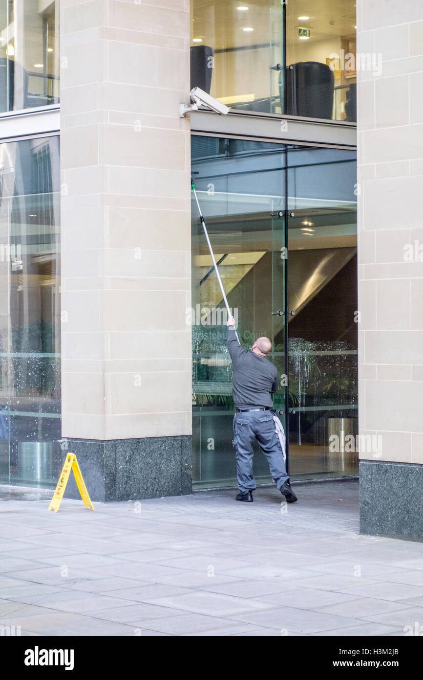 Window cleaner cleaning windows on an office building in London Stock ...