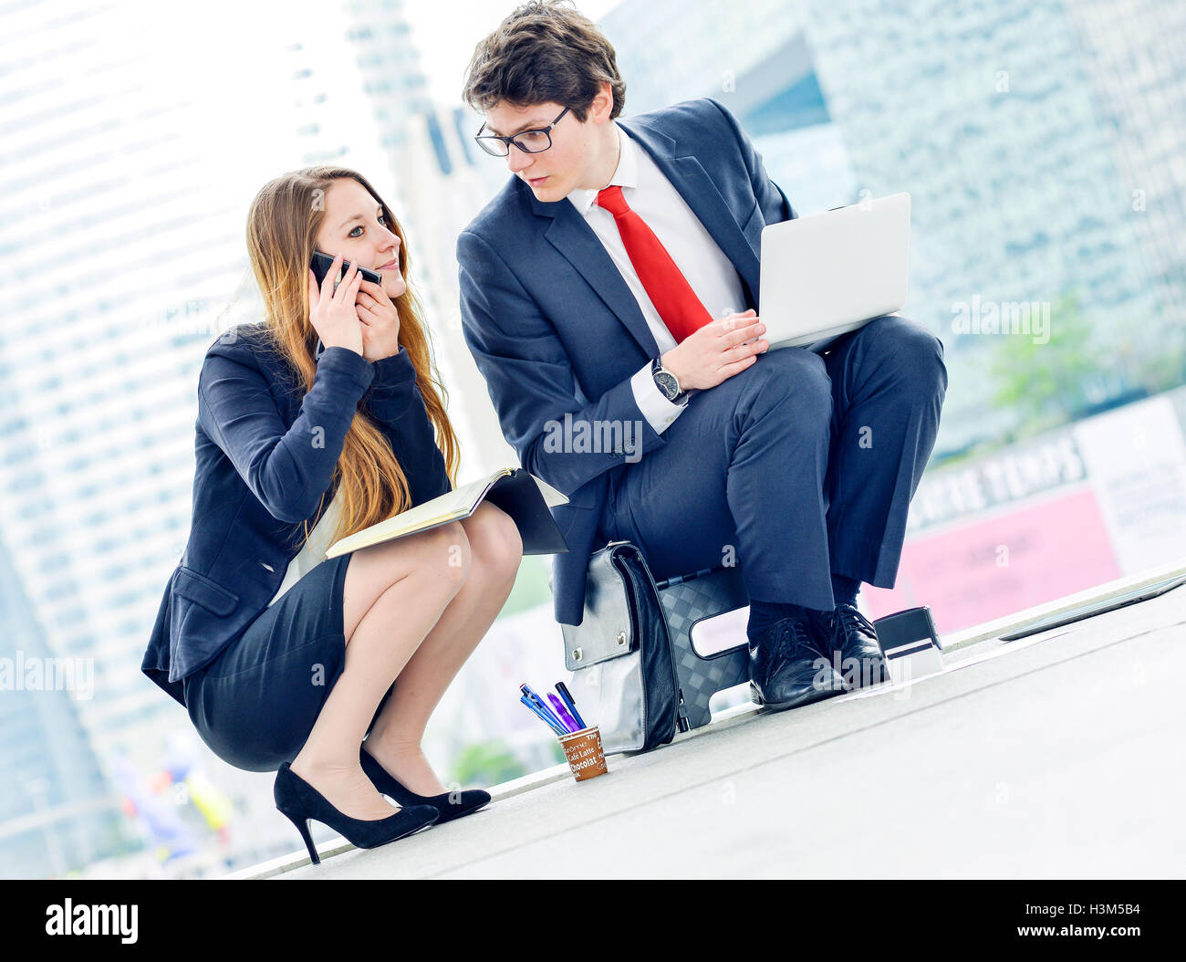 Junior executives dynamics working outside of their office Stock Photo ...