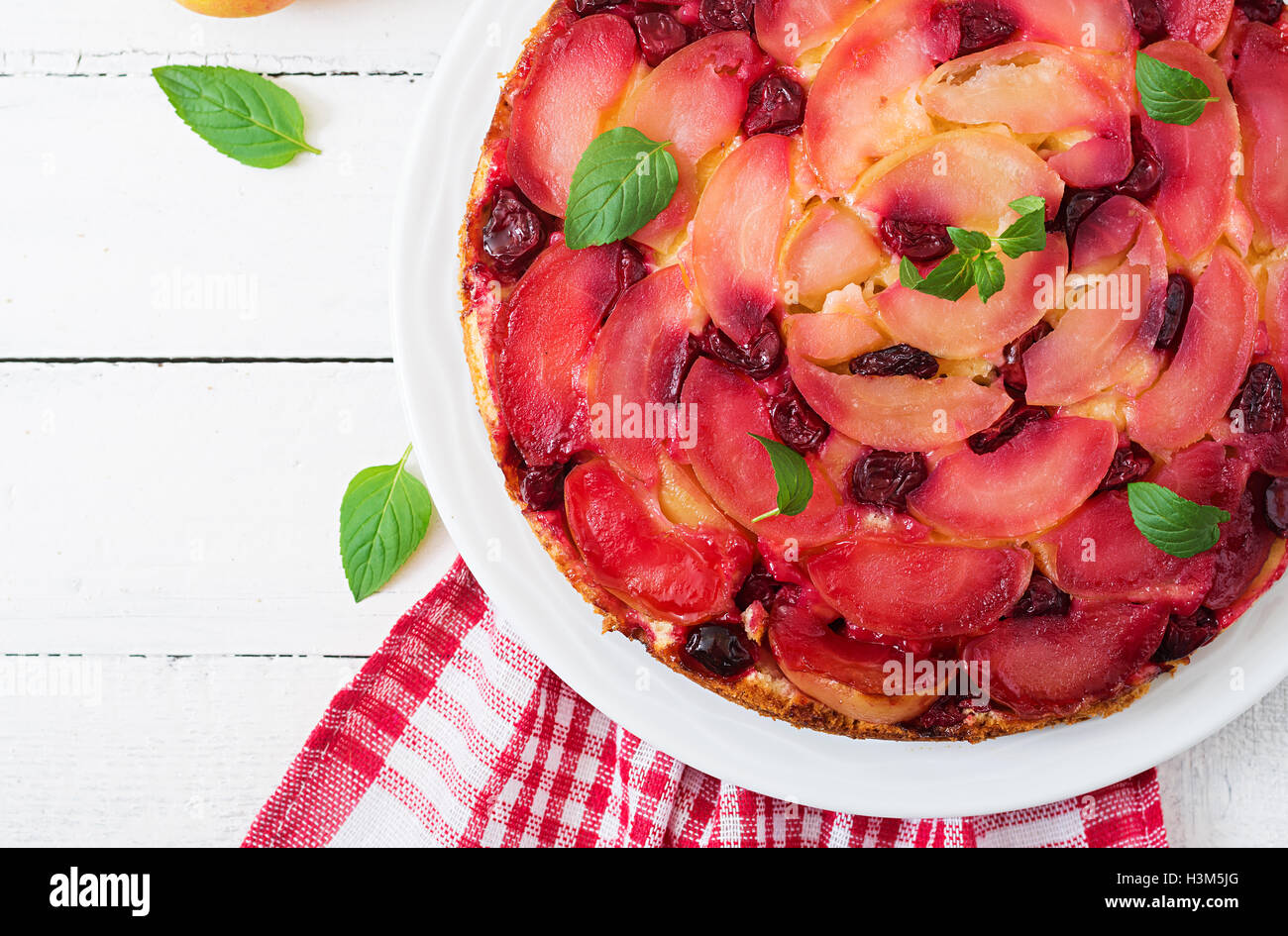 Delicate biscuit cake with apples and cherries Stock Photo - Alamy