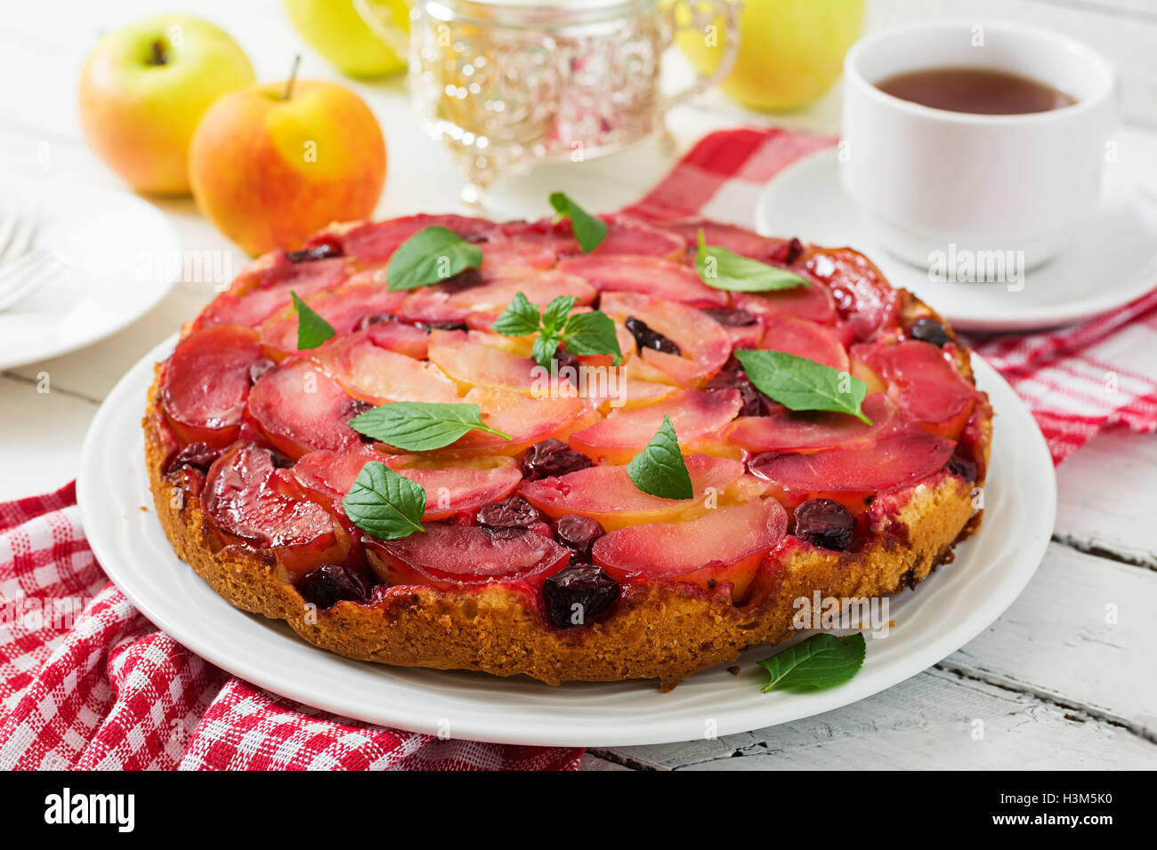 Delicate biscuit cake with apples and cherries Stock Photo - Alamy