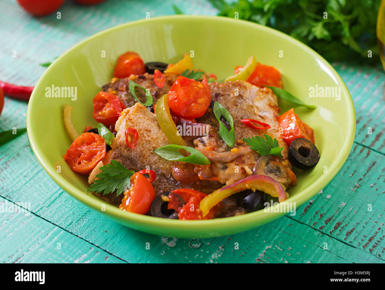 Fried hake fillet with tomato and olives in the Mediterranean style ...