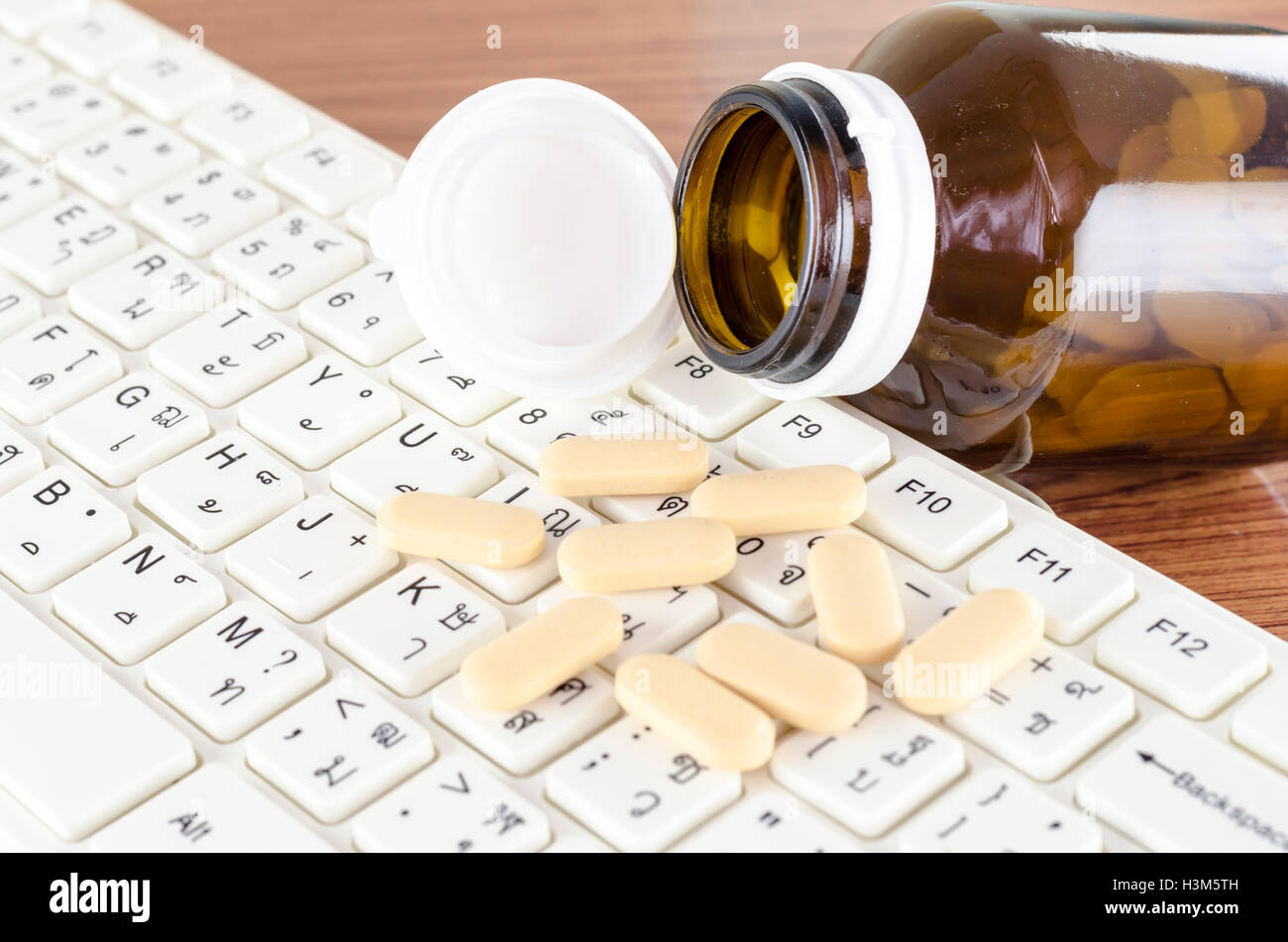 pills on keyboard computer Stock Photo - Alamy