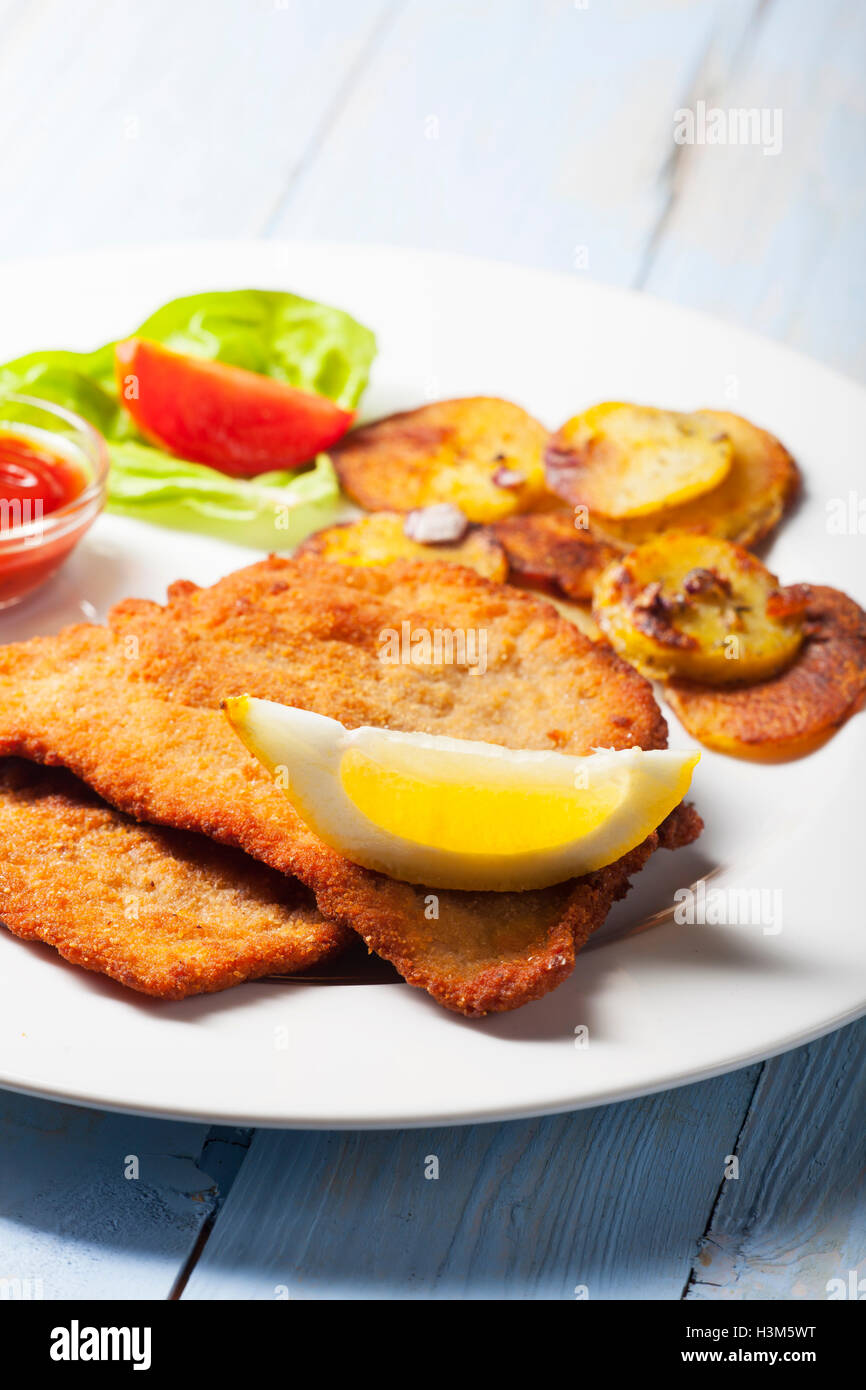 wiener schnitzel with roasted potatoes Stock Photo - Alamy