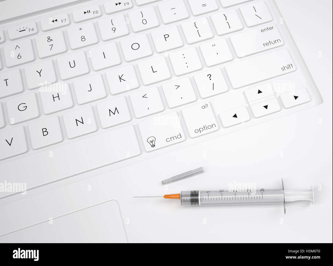 Syringe on the keyboard Stock Photo - Alamy