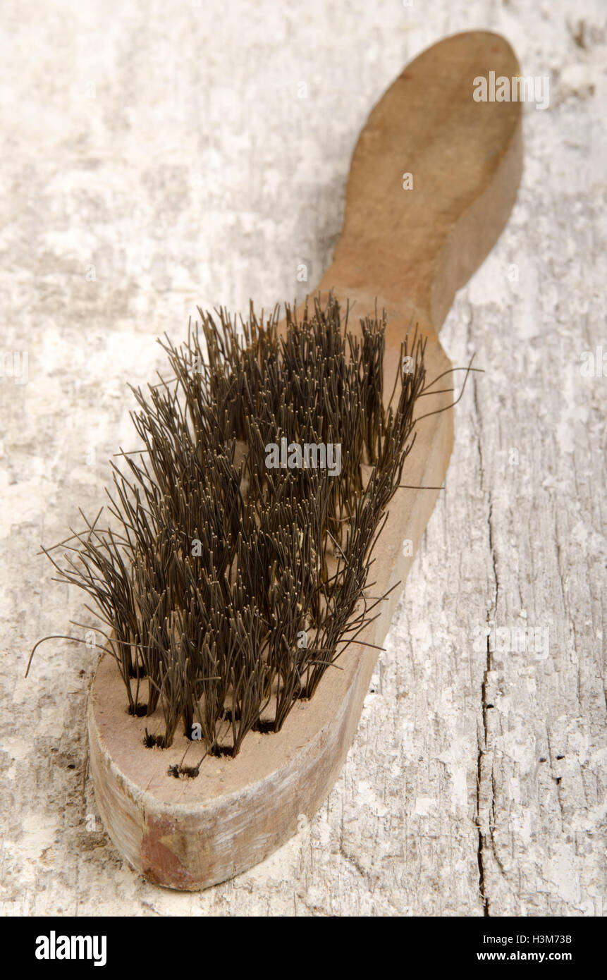 rusty metal brush on white wood Stock Photo - Alamy