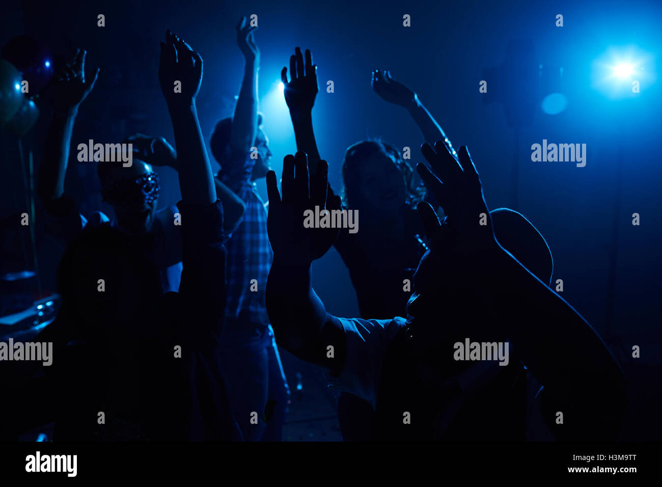 Group of ecstatic people dancing in night club Stock Photo - Alamy