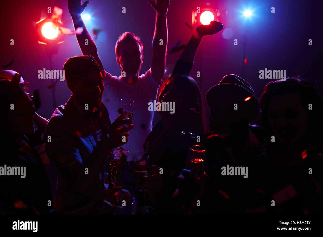 Cheering people with champagne having fun at party Stock Photo - Alamy