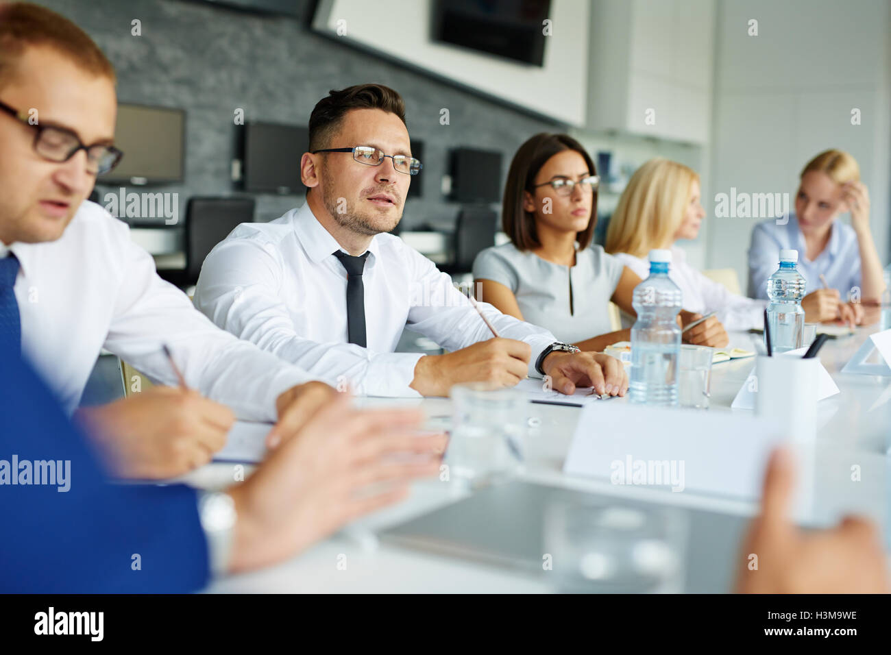 Business leader and his employees working at seminar Stock Photo - Alamy