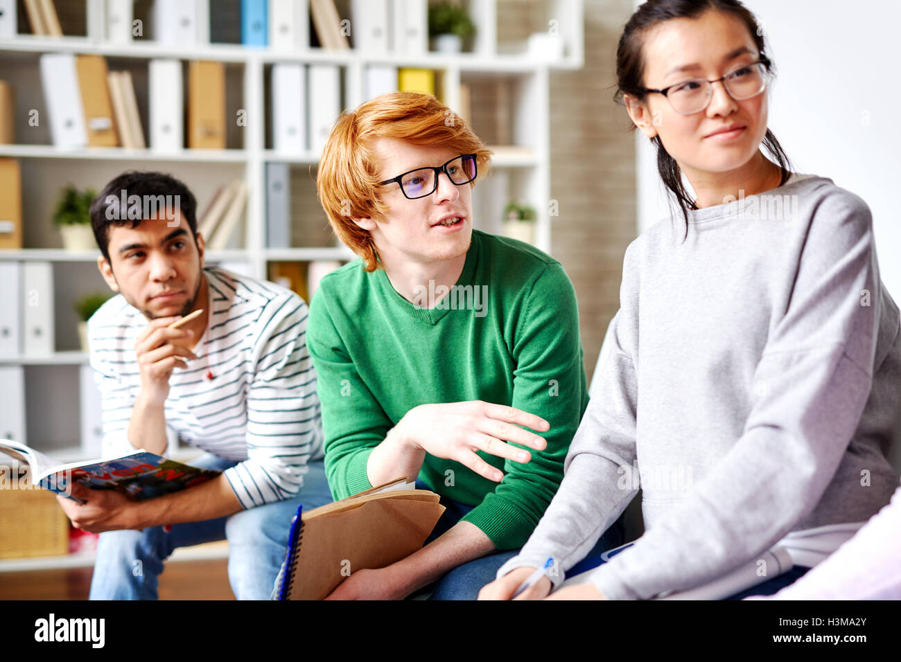 Teenage guy explaining his idea to teacher at lesson Stock Photo - Alamy