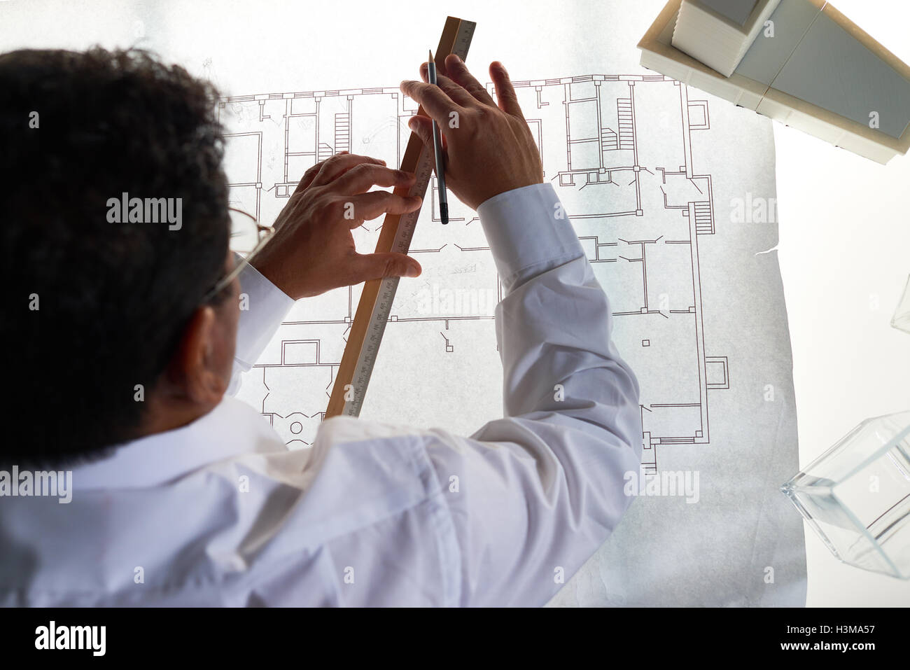 Architect with ruler and pencil making sketch Stock Photo - Alamy