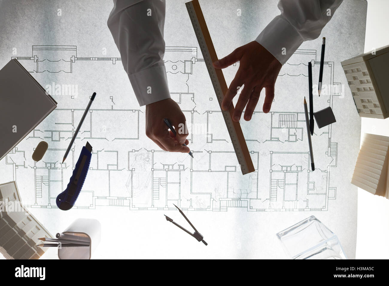 Engineer hands with ruler measuring something in sketch Stock Photo - Alamy