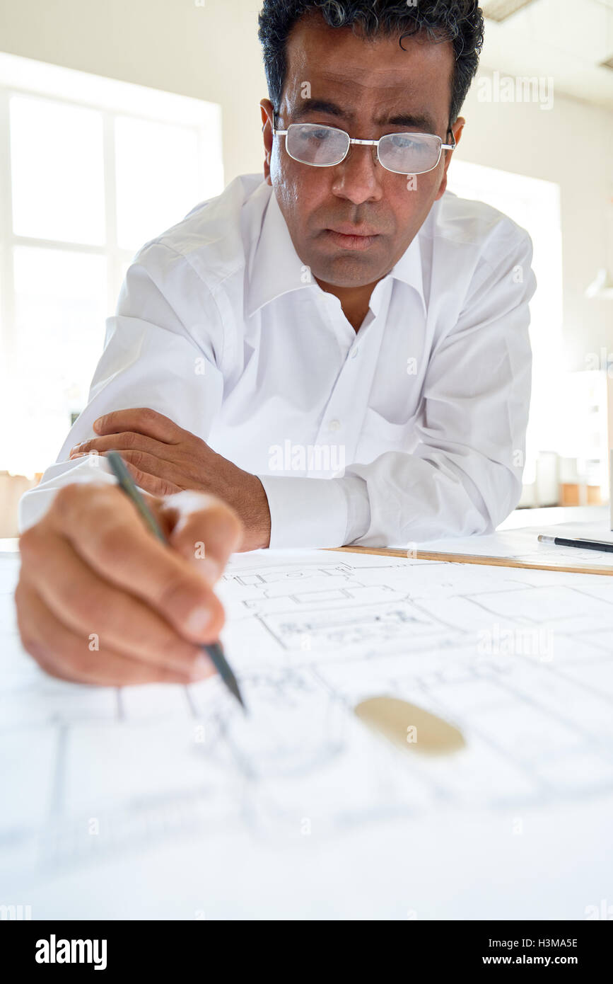 Experienced architect drawing sketch and making corrections Stock Photo ...