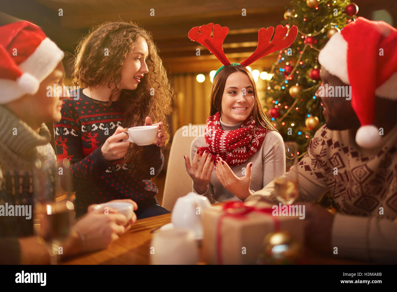 Young friends enjoying Christmas party at home Stock Photo - Alamy