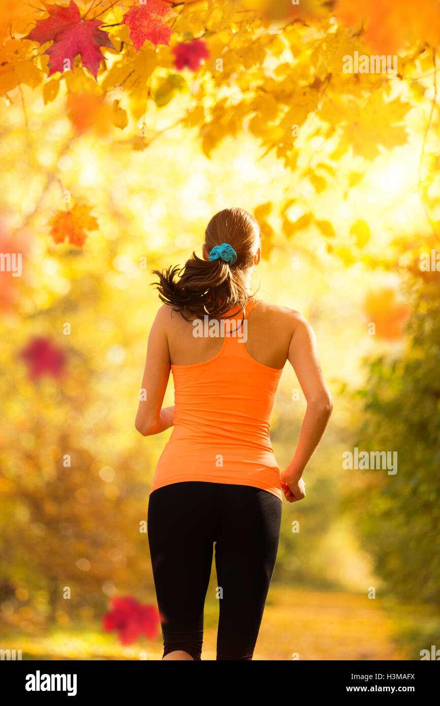 Athlete young woman running in morning sunrise training for marathon ...