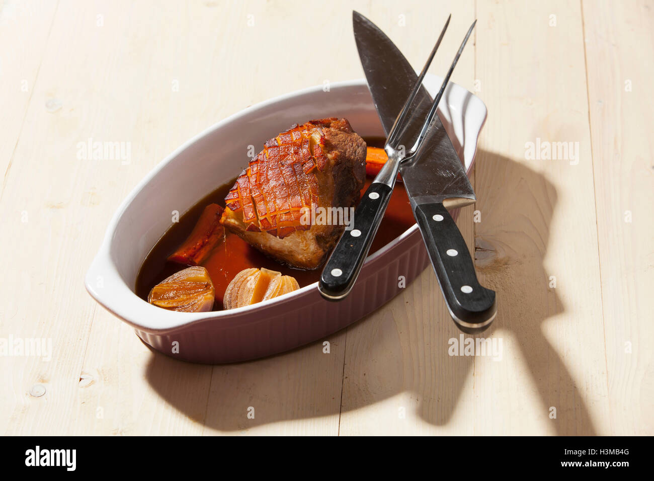 cooking a bavarian roast pork dish Stock Photo - Alamy