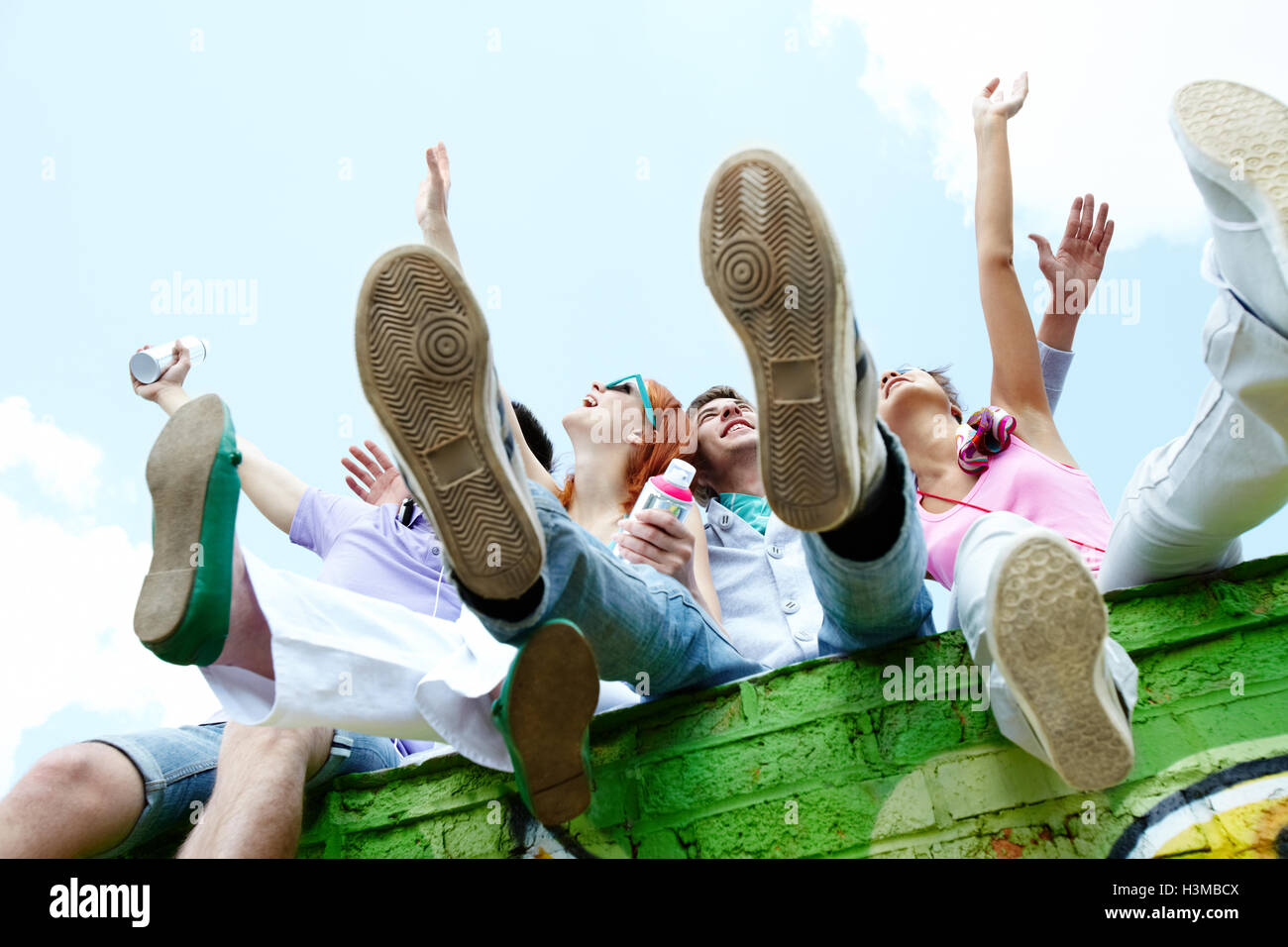 Friends on the wall Stock Photo - Alamy