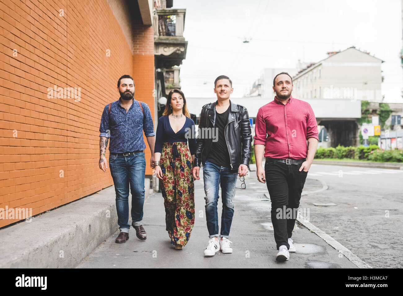 Group of friends walking on sidewalk Stock Photo - Alamy