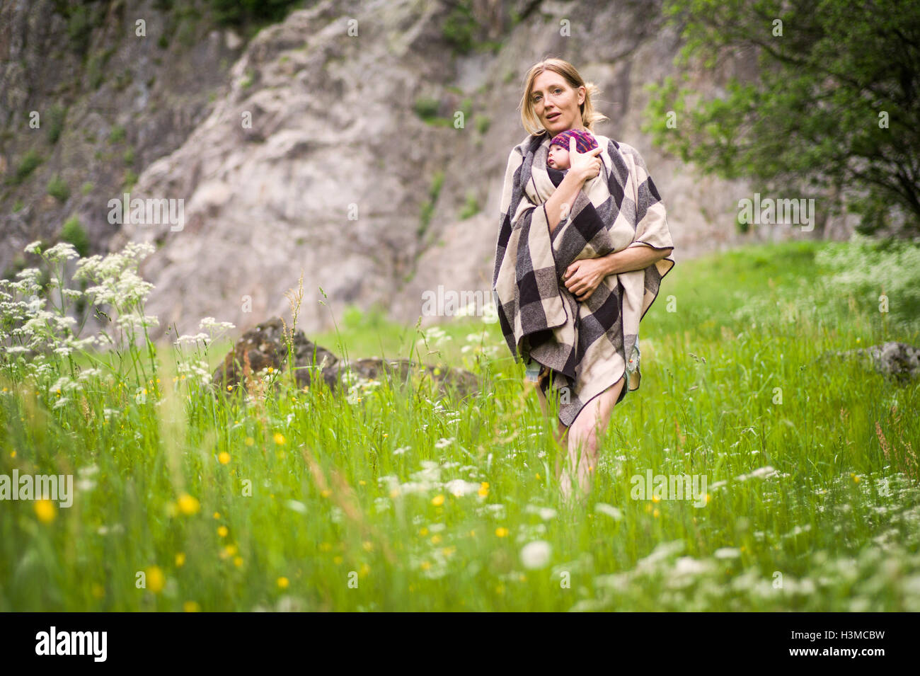 Mother carrying baby girl through meadow Stock Photo - Alamy Mother carrying baby girl through meadow Stock Photo - Alamy