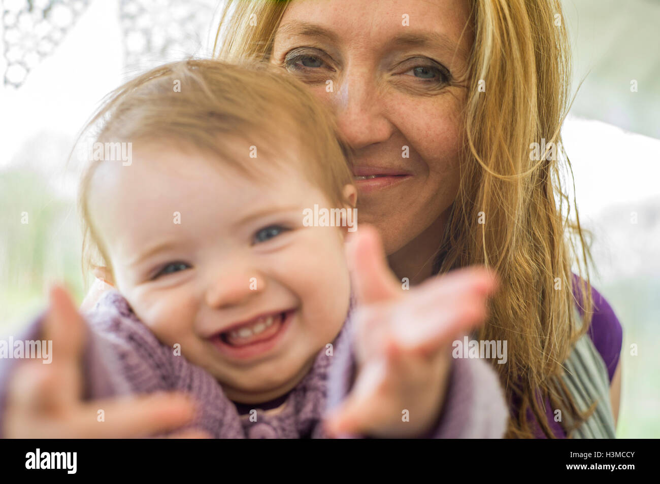 Portrait of mother and daughter looking at camera smiling Stock Photo ...