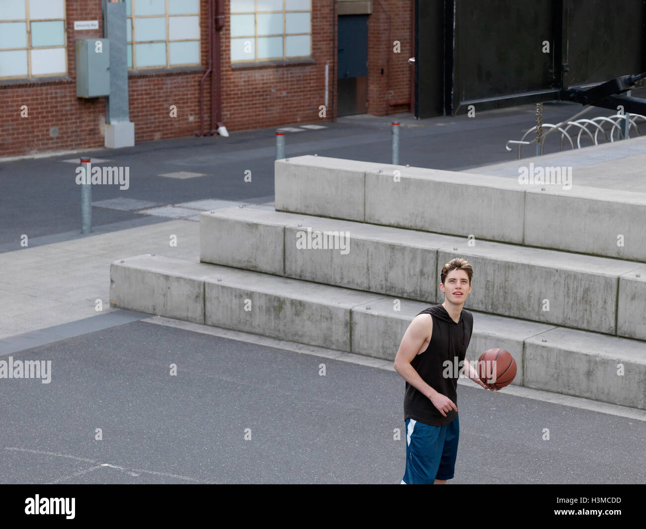Young man playing basketball in outdoor court Stock Photo - Alamy